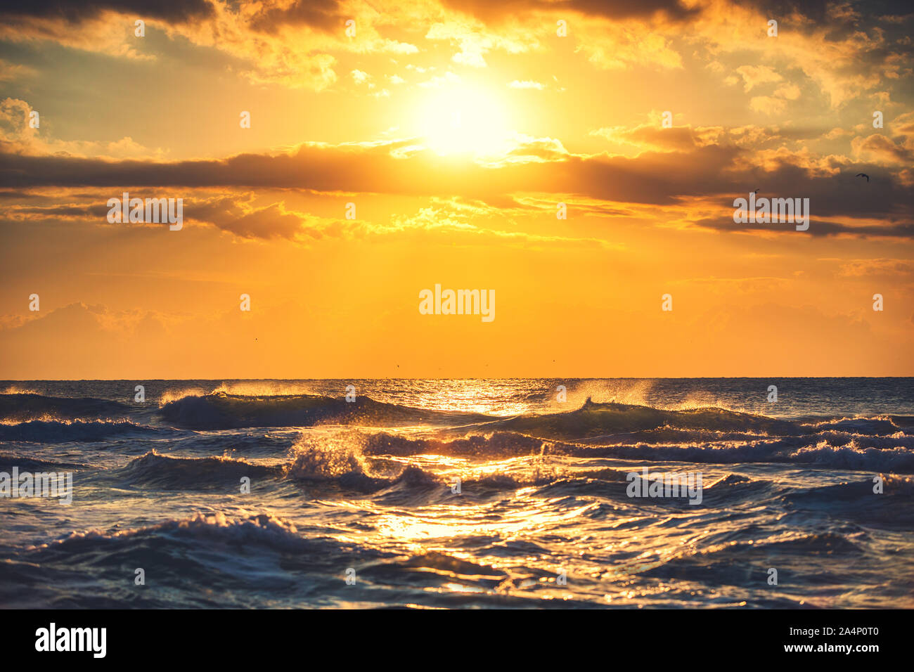 Beautiful cloudscape over the golden sunrise wave Stock Photo - Alamy