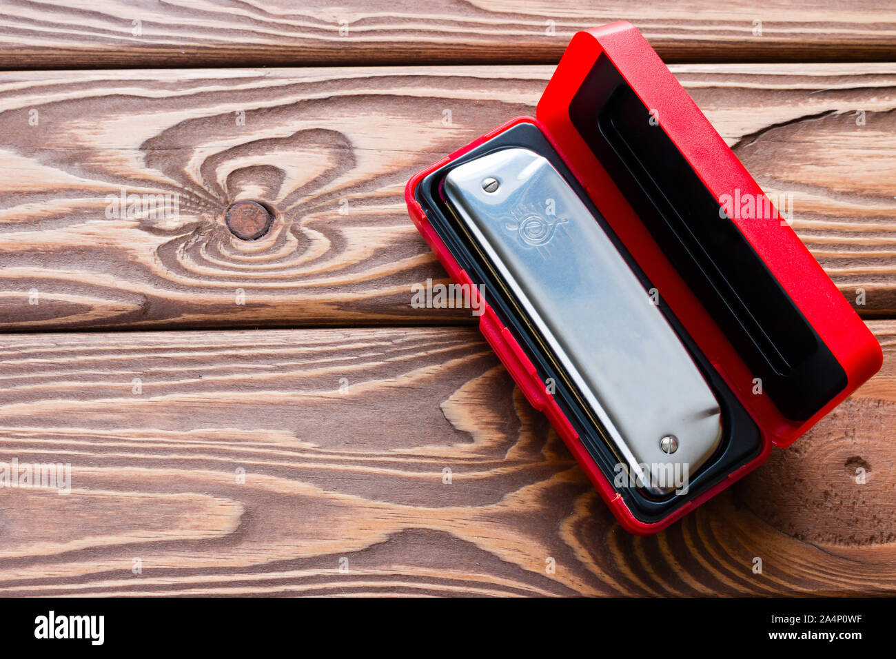 harmonica in a red box on a wooden background Stock Photo - Alamy