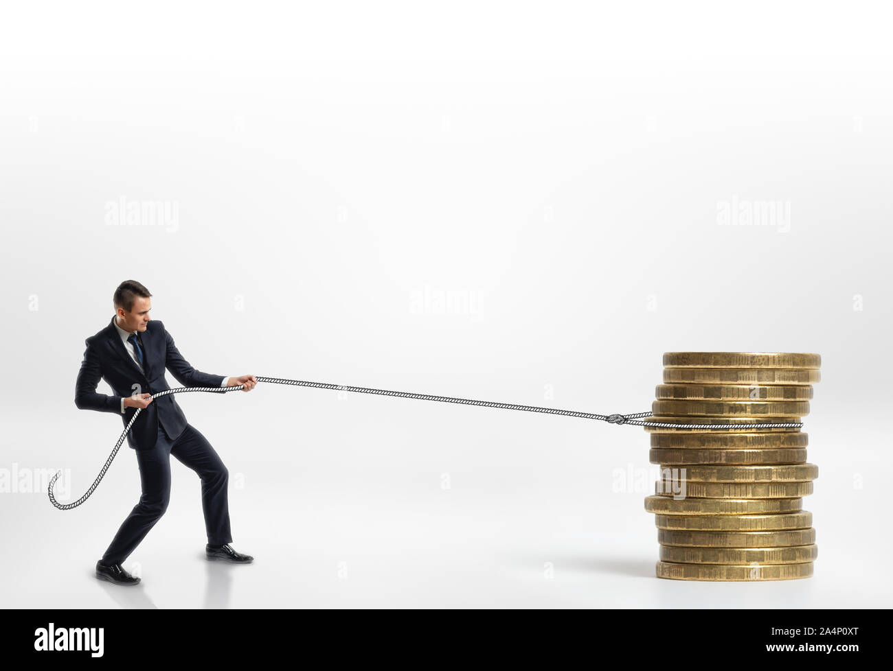 Businessman pulling stack of big golden coins with a rope isolated on ...