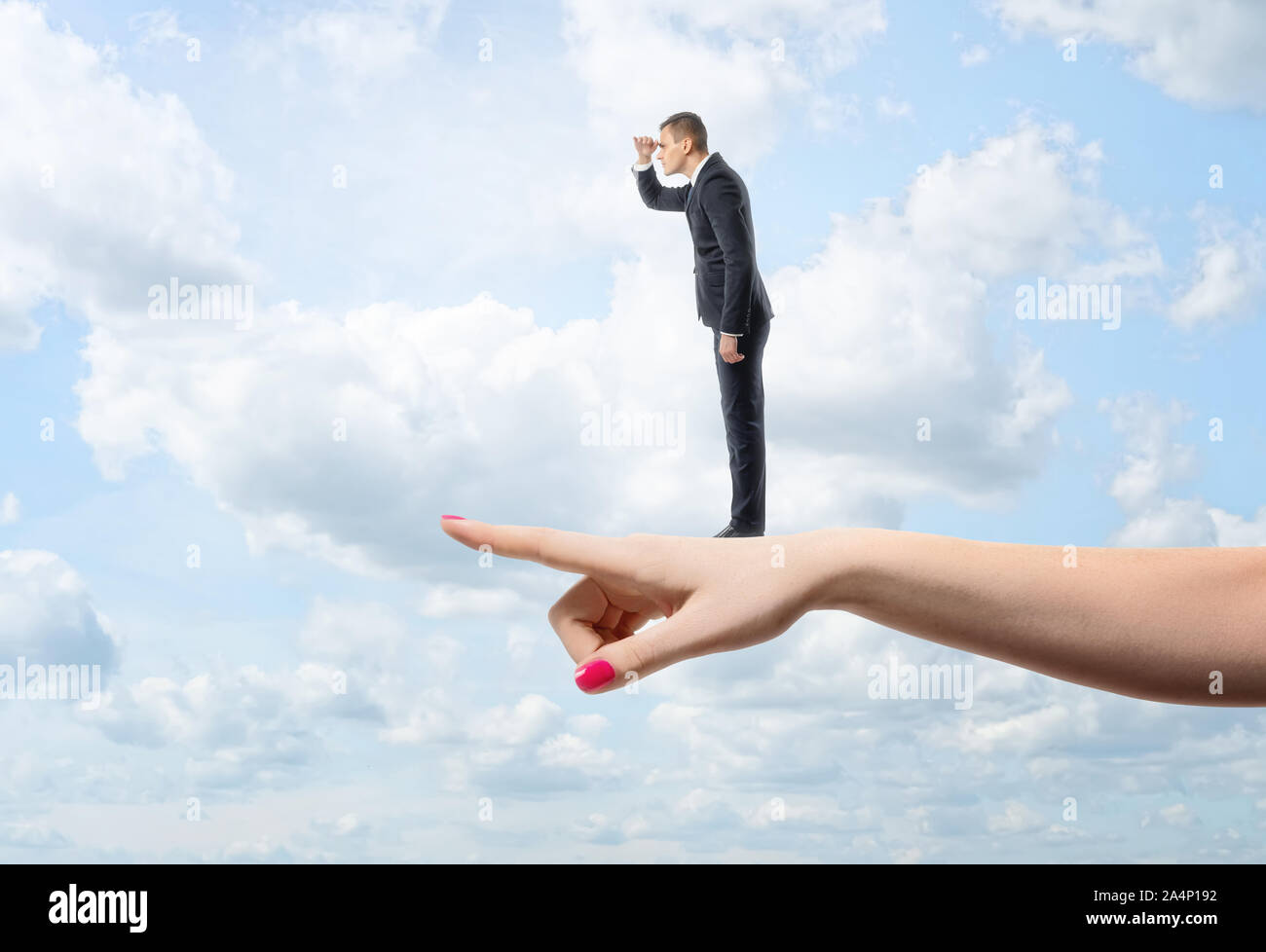 Businessman in profile looking straight ahead standing on giant female ...