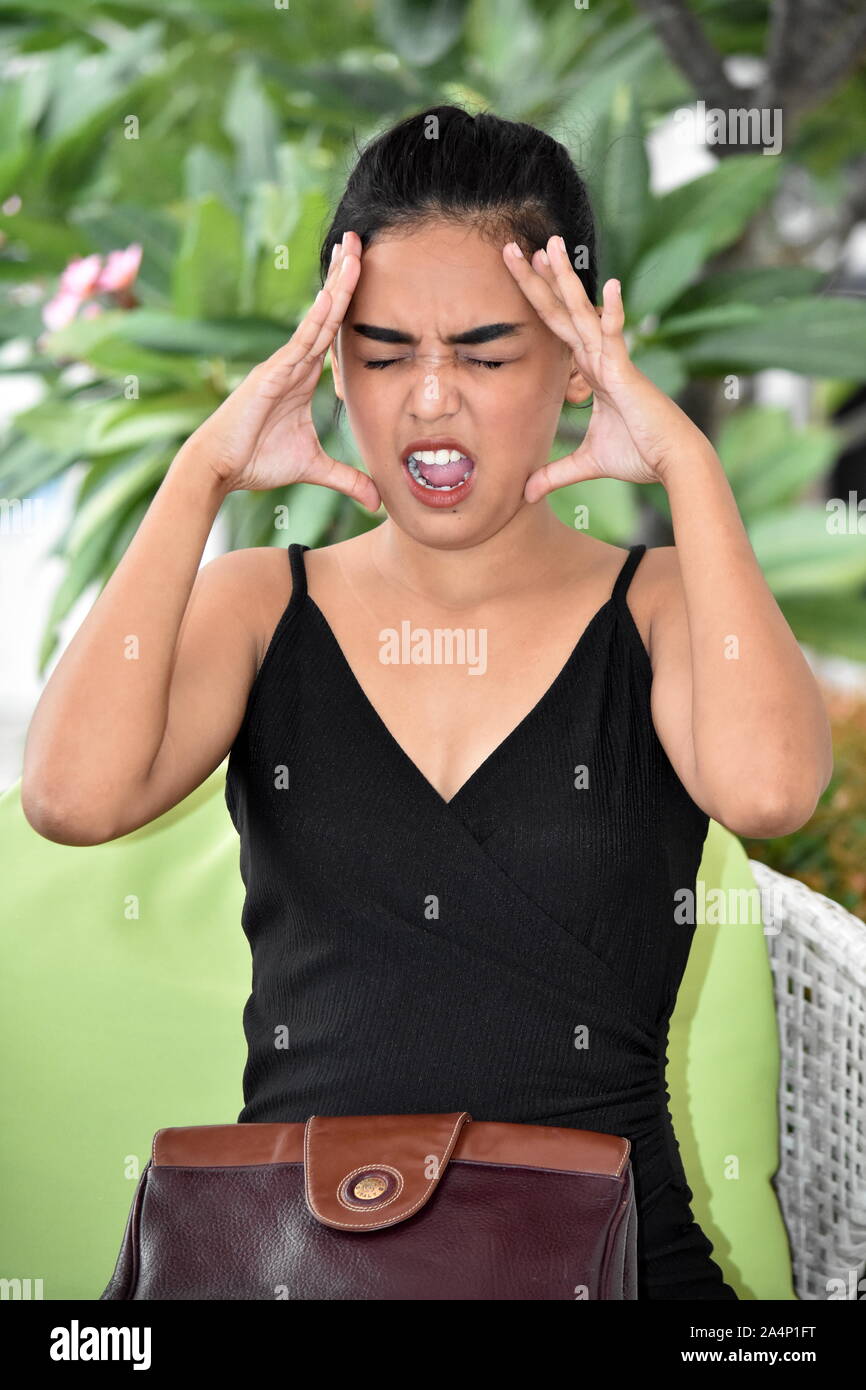 Cute Asian Female Under Stress While Sitting Stock Photo - Alamy