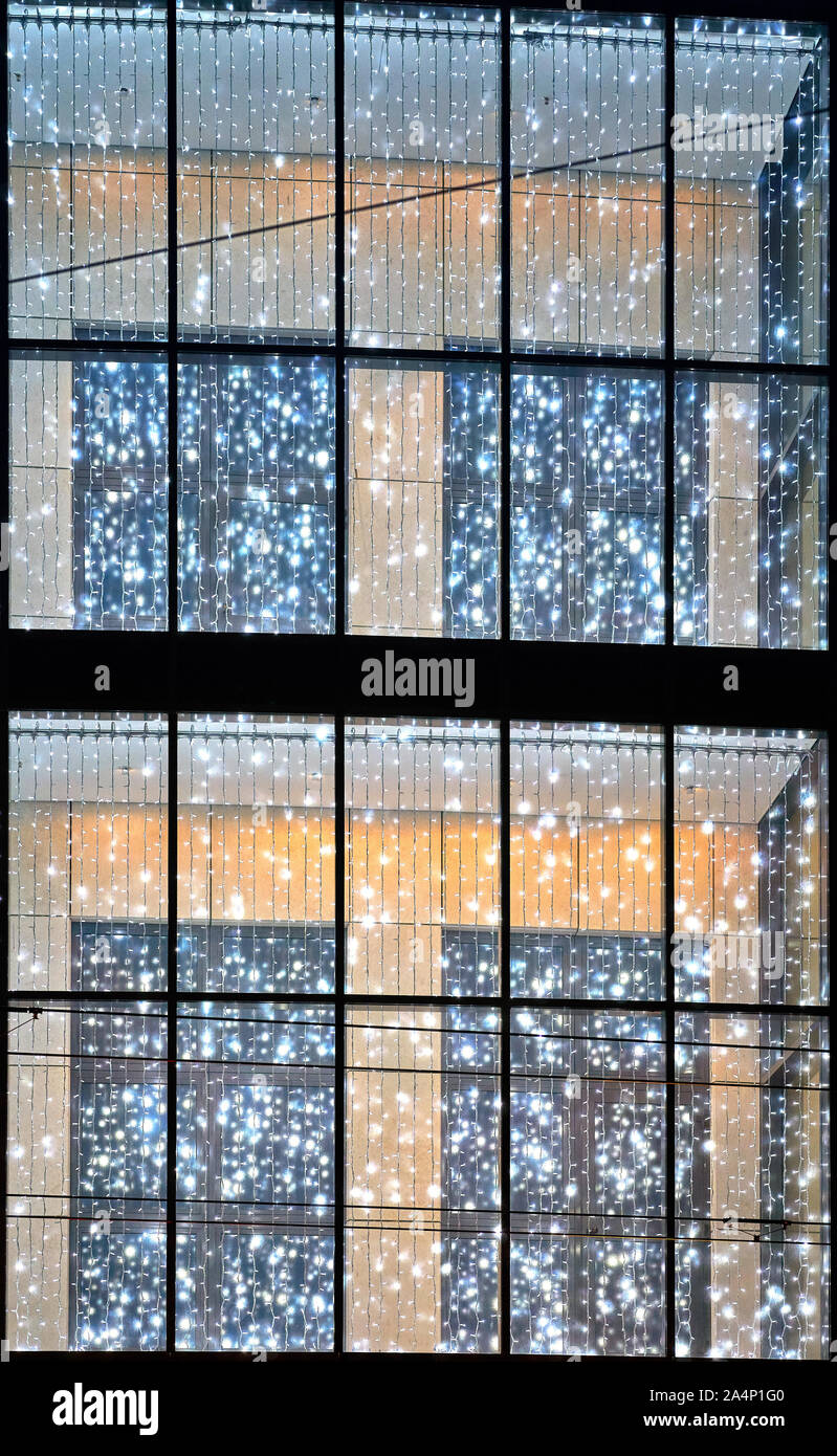 Fairy lights in a big window as a christmas background Stock Photo - Alamy