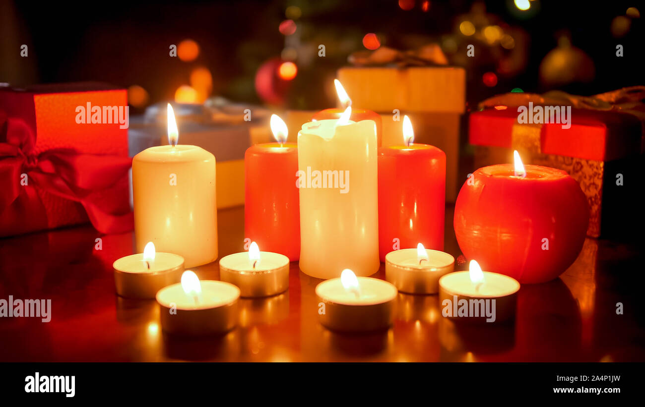 Beautiful background with burning candles against glowing Christmas ...