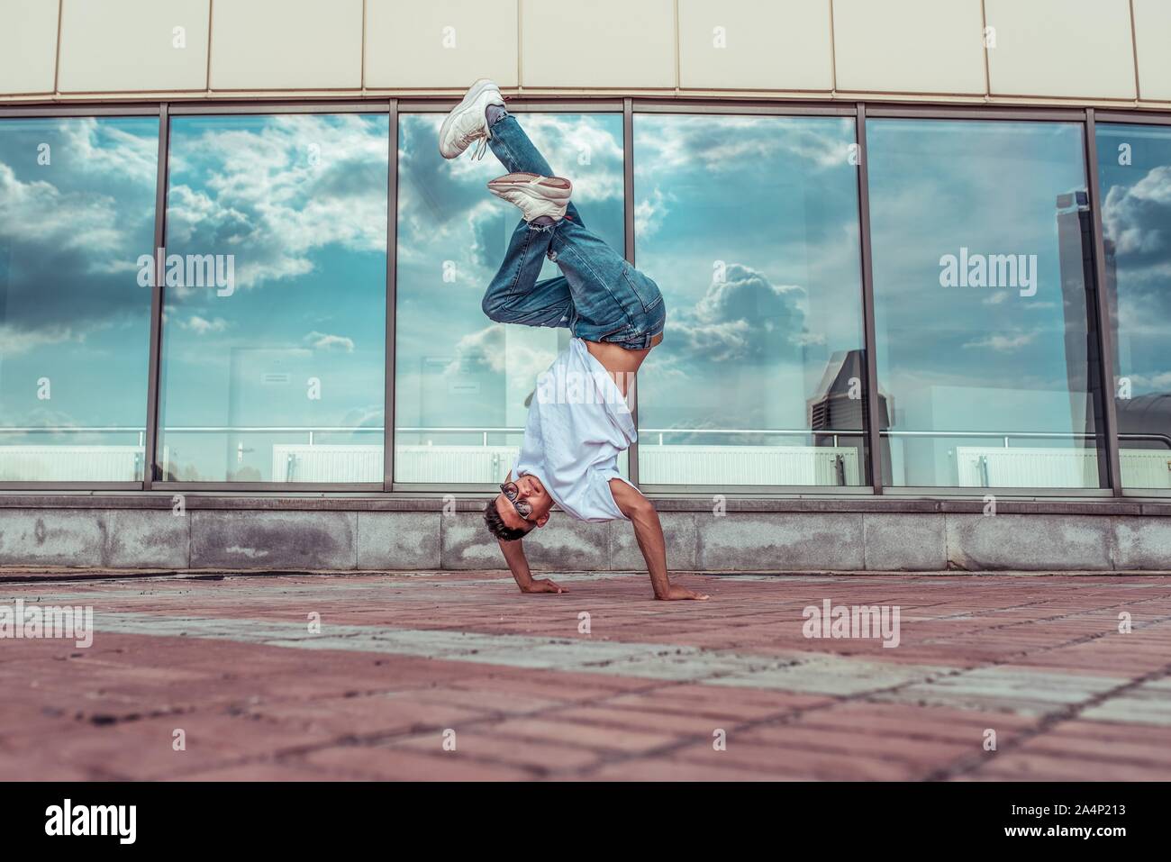 Handstand dancer dancing break dance, hip hop. In summer city ...