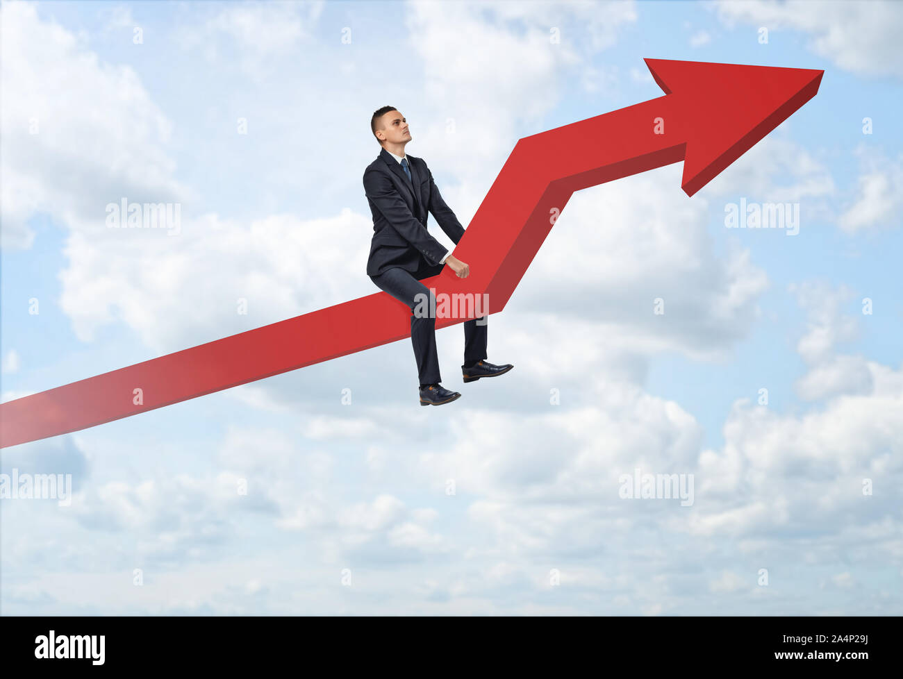 Businessman sitting on big red line graph with an upturned arrow Stock ...