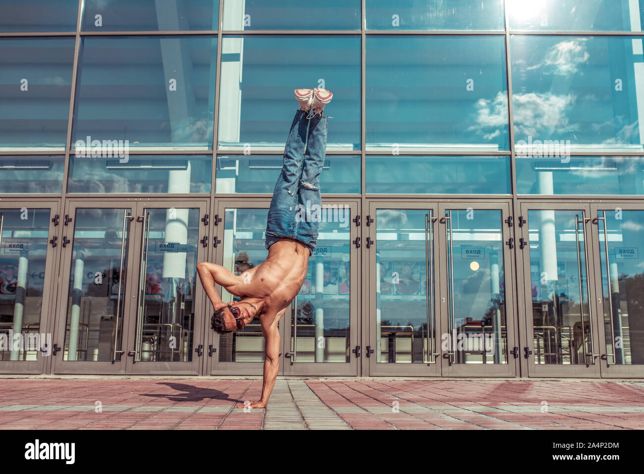 dancer in jump stands on one arm, acrobat actor break dance, hip-hop ...