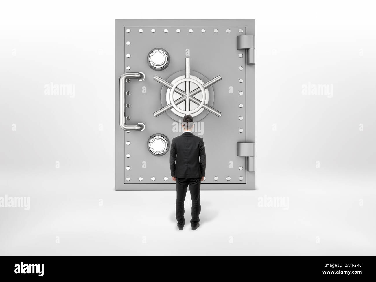 Businessman standing back to us looking at the giant safe door, all ...