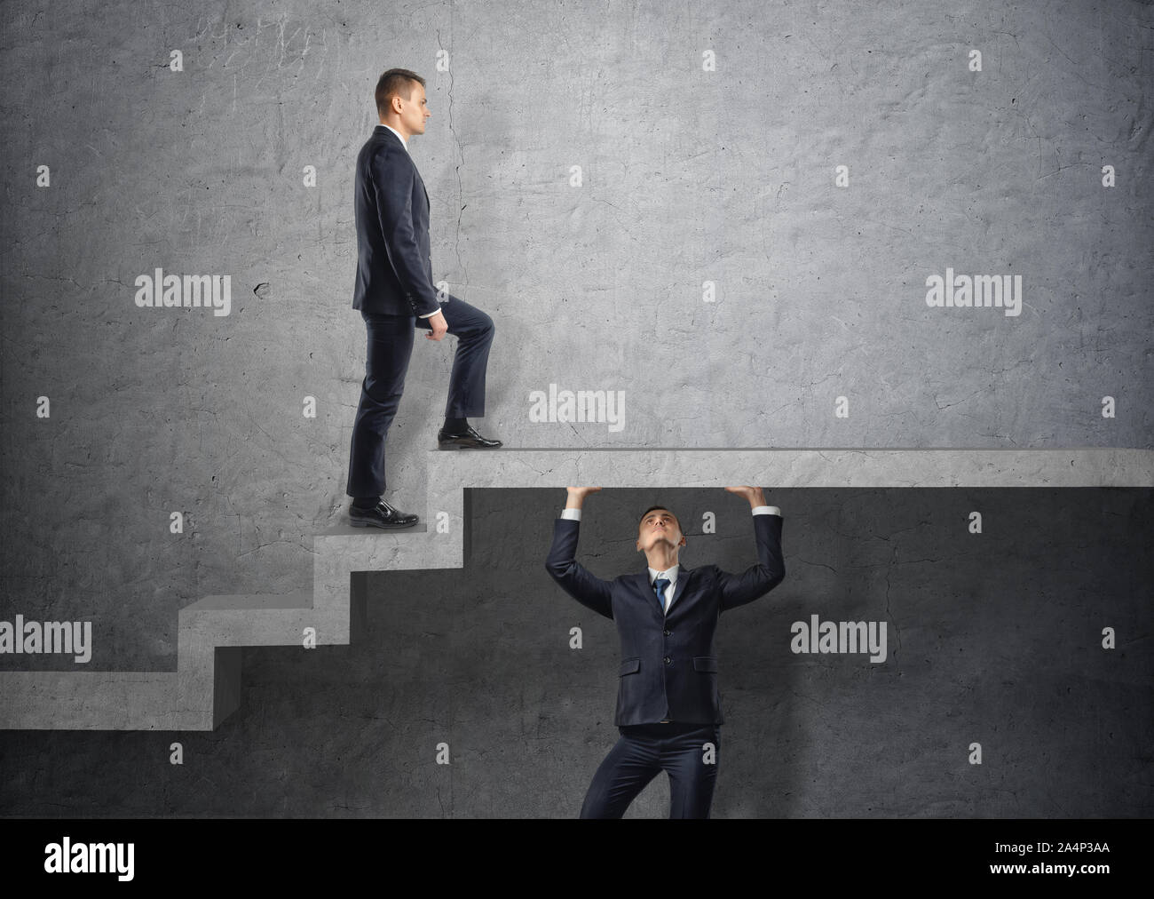 Businessman climbs the concrete stairs, which the other person keeps ...