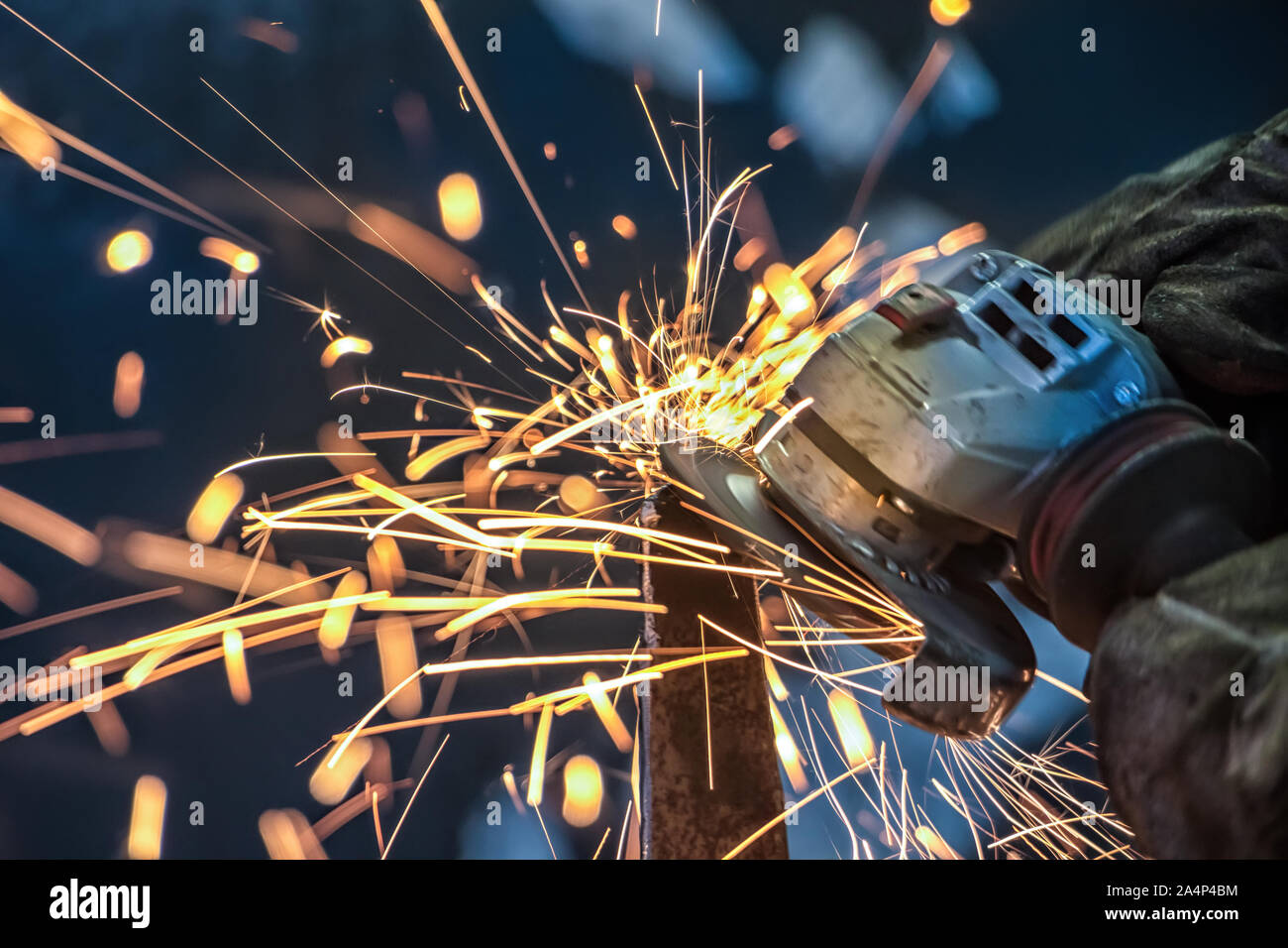 Sparks from an African man grinding metal Stock Photo - Alamy