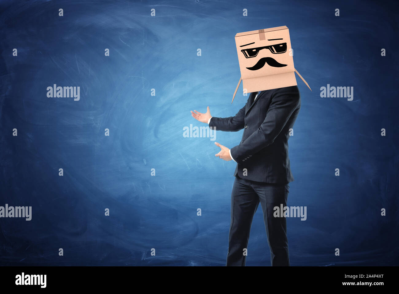 Businessman wearing cardboard box with drawn sun glasses and moustache ...