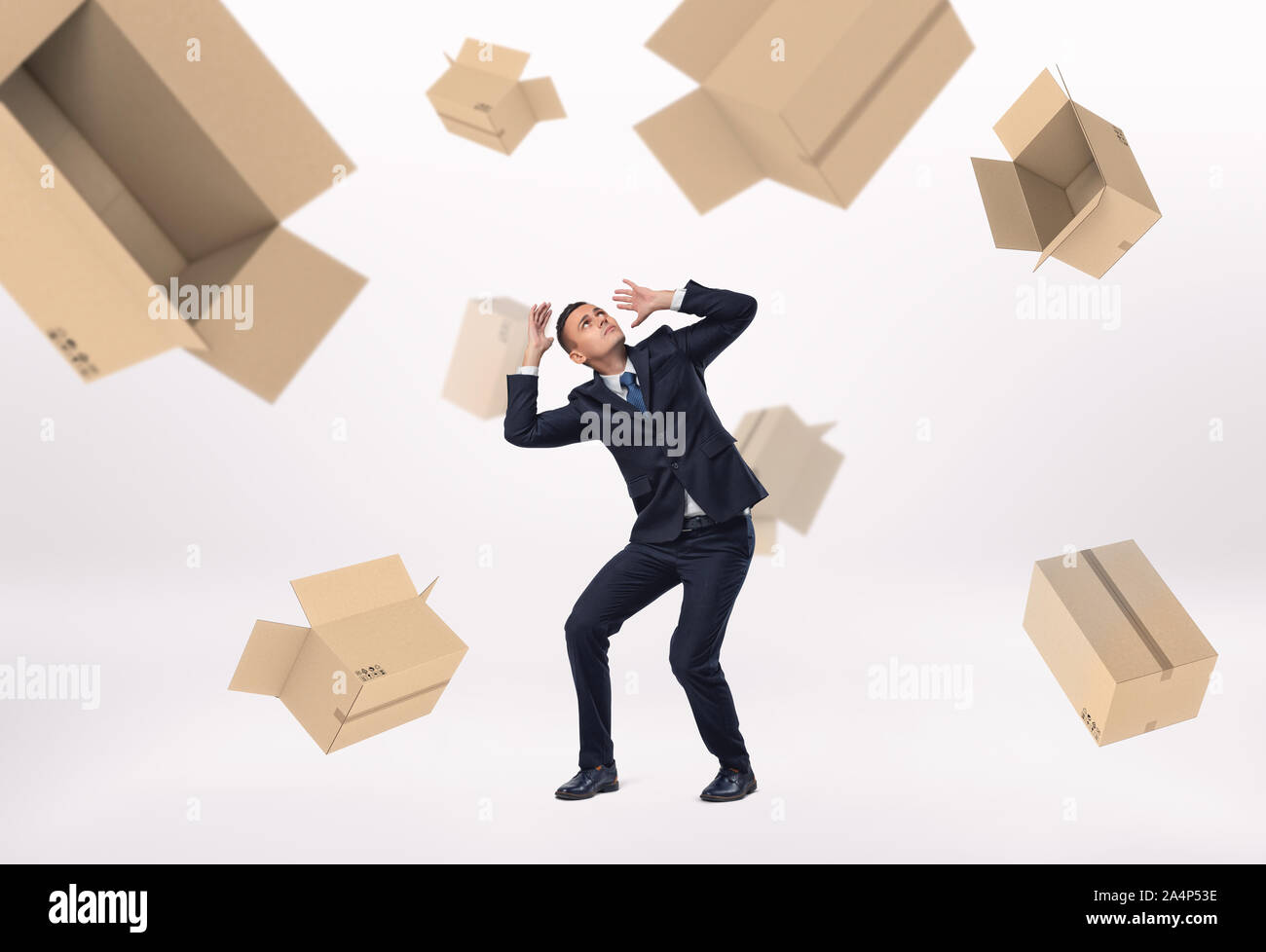 Frightened businessman and empty boxes falling on him Stock Photo - Alamy