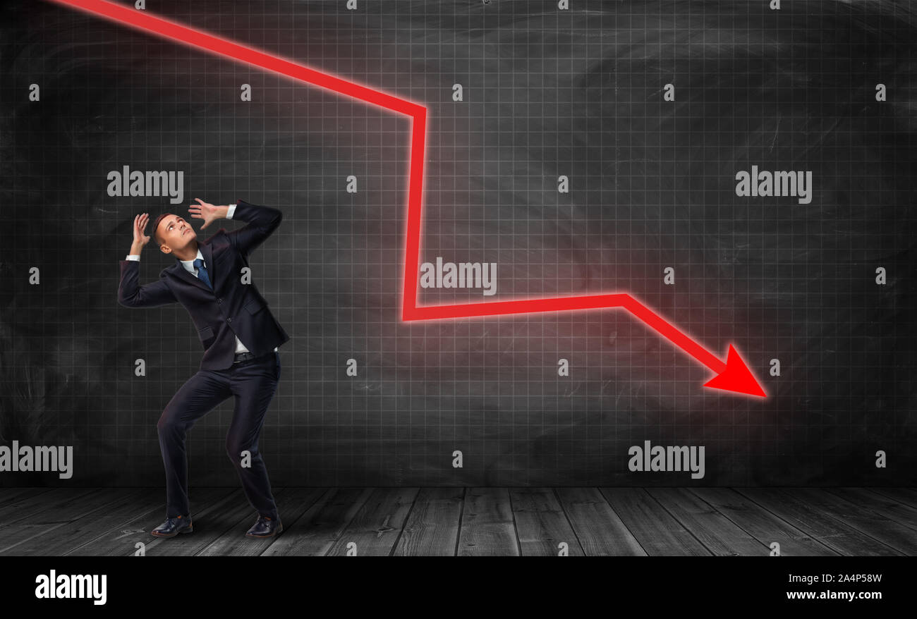 Small frightened businessman under huge red kinked arrow pointing down ...