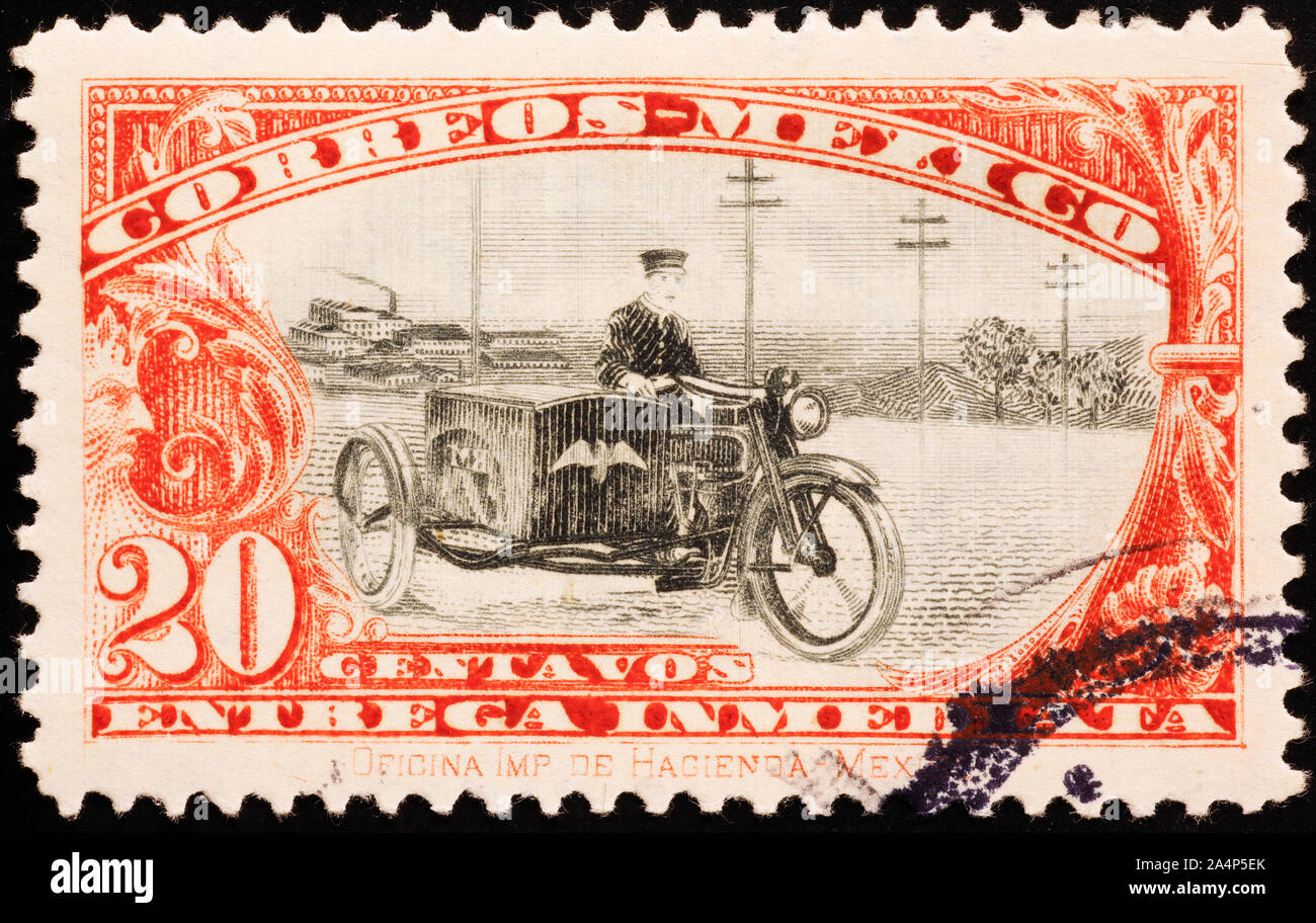 Postman on motorbike in old mexican postage stamp Stock Photo - Alamy