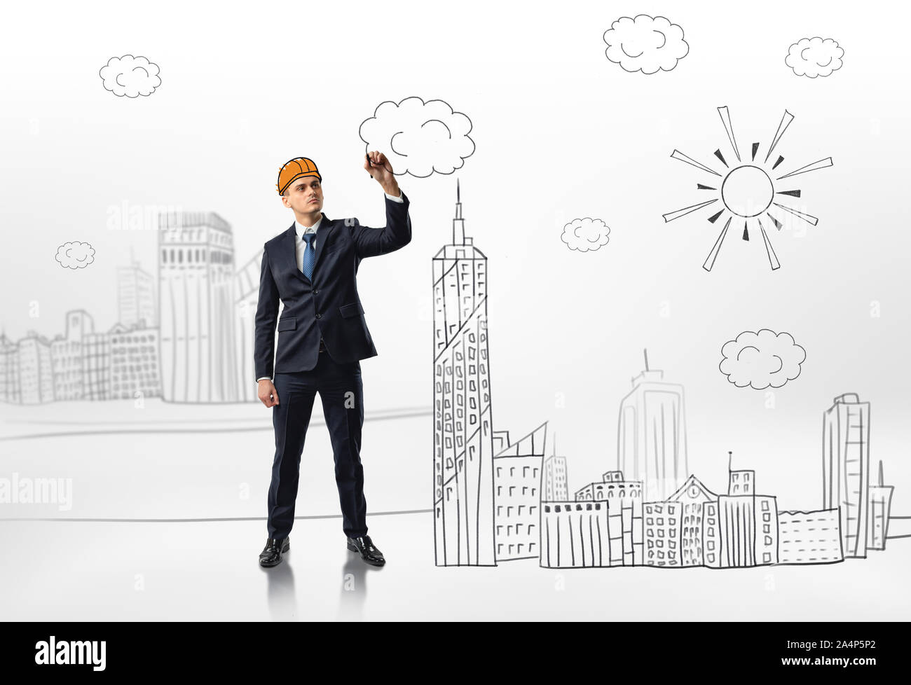 Businessman on white background drawing a cloud when several houses, a ...