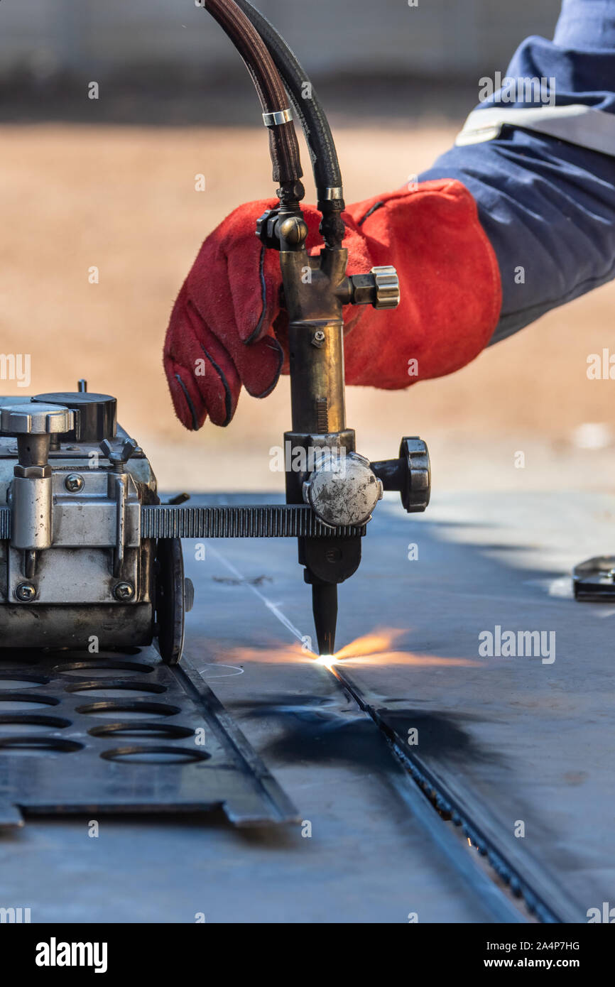 Motswana welder worker in a Botswana workshop, using an acetylene torch ...