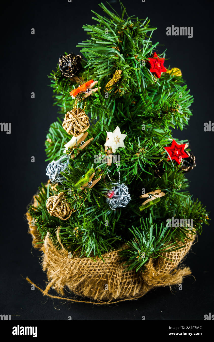 small christmas tree on black background Stock Photo - Alamy