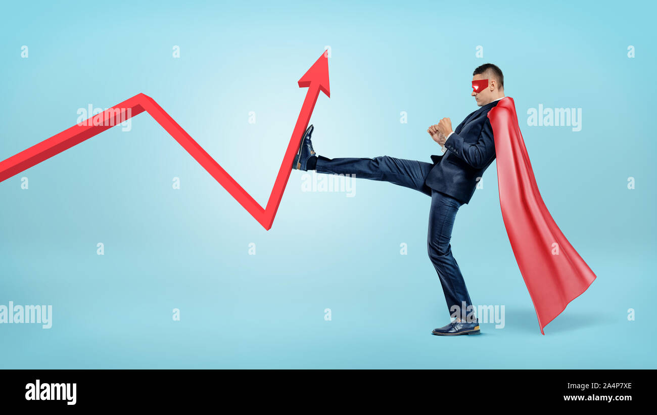 A businessman in a red superhero cape beating a red statistic arrow ...