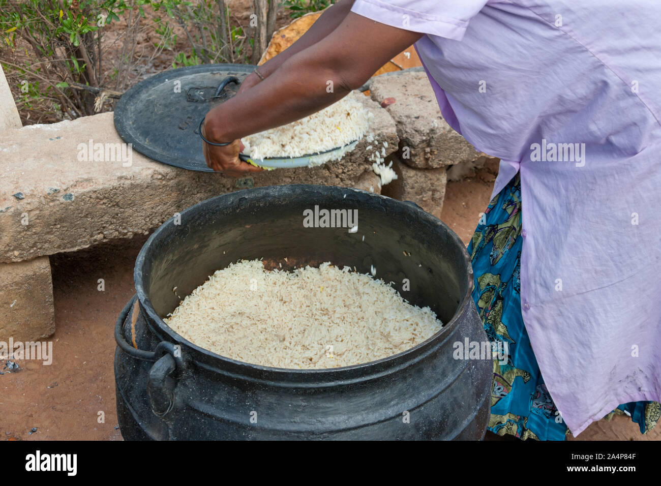 Traditional African food, rice, cooked outdoors in the yard Stock Photo ...