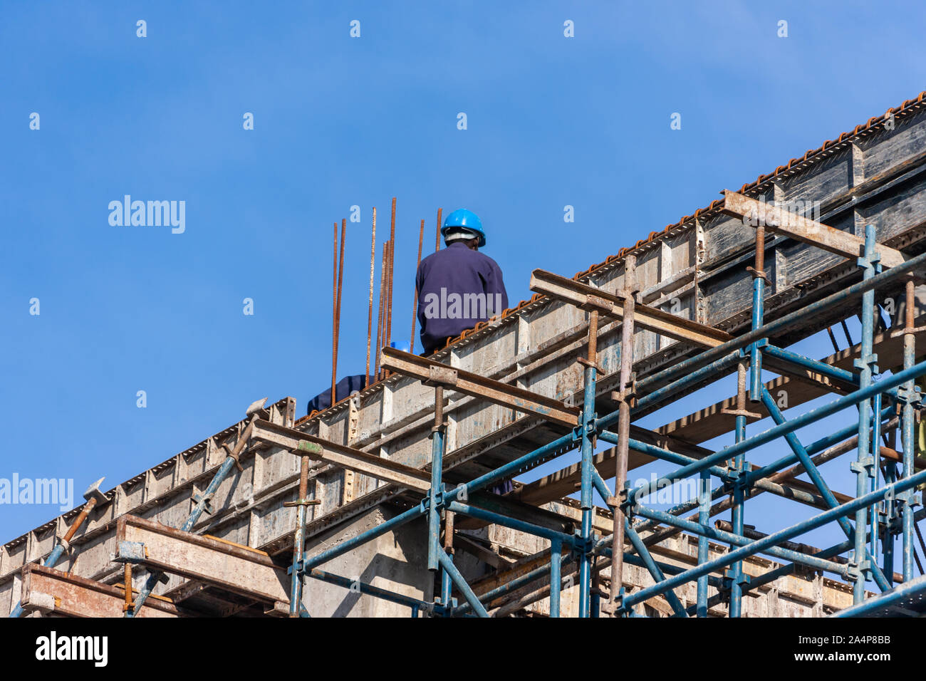 African construction workers in Botswana , working on a high building ...
