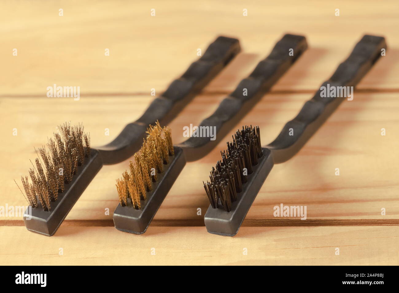 few small brushes made with wire, brass and plastic Stock Photo - Alamy