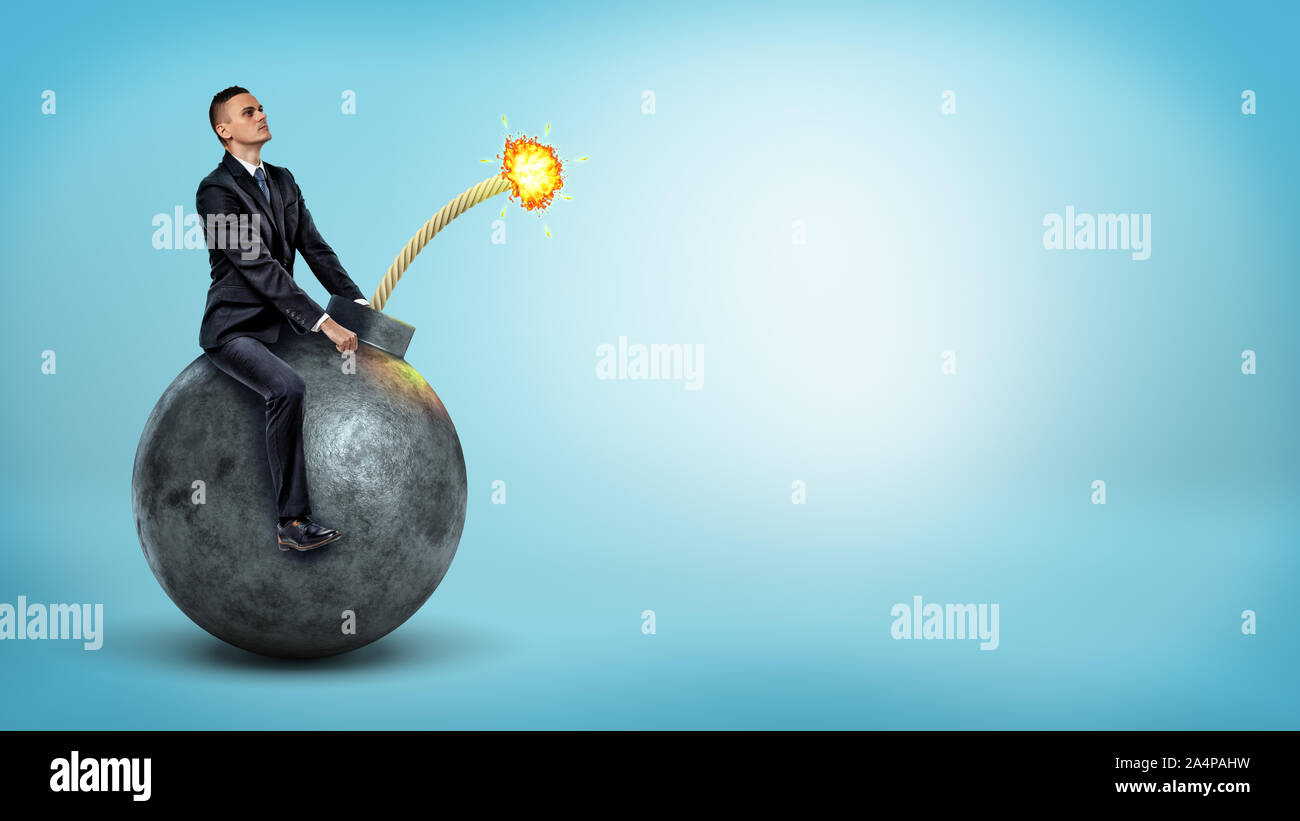 A small businessman riding a big round bomb with a lit fuse on blue ...