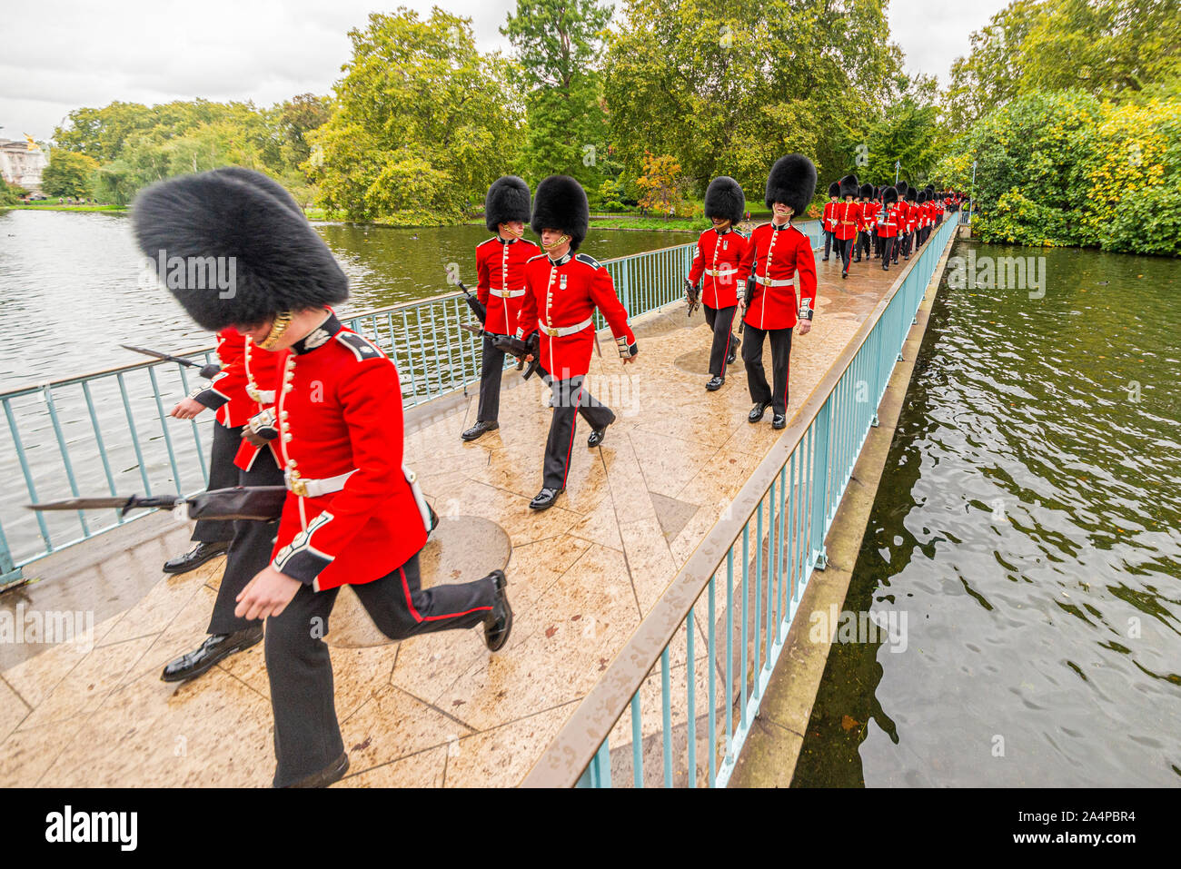 British Army Guards breaking step crossing the Blue Bridge in St James ...