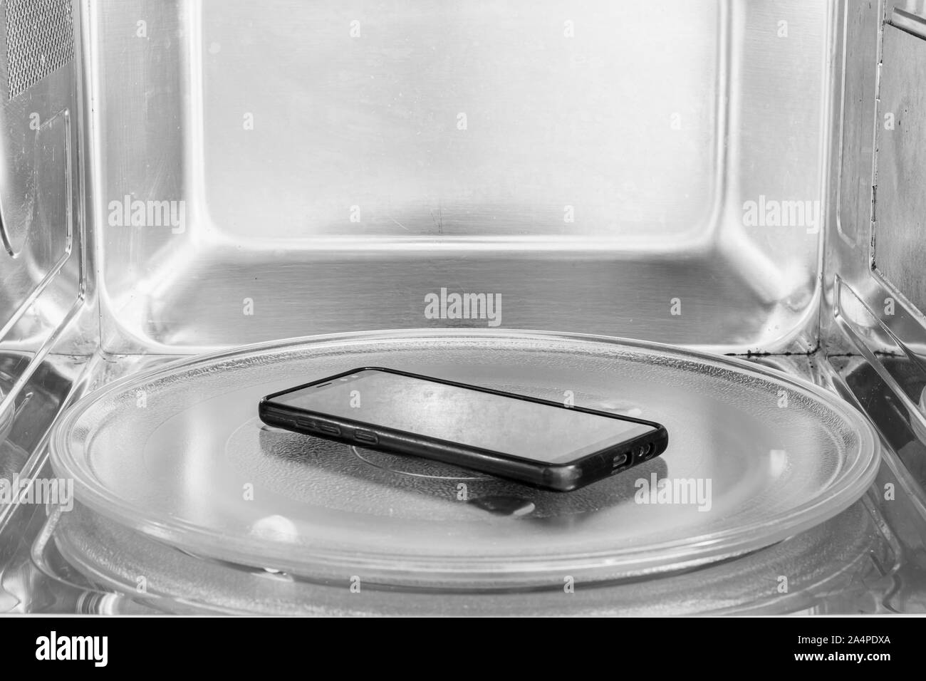 Smartphone inside the microwave. Warming the phone on the microwave ...
