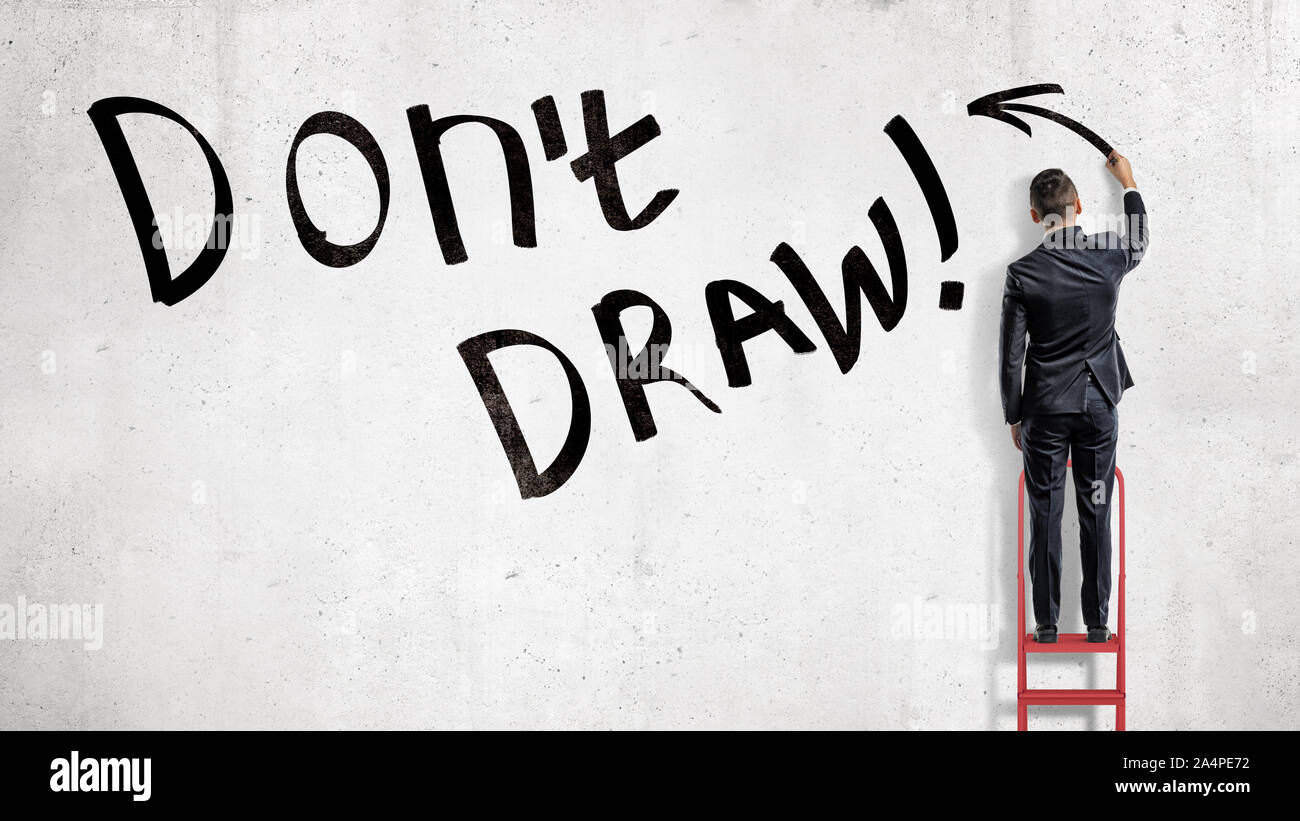 A businessman stands on a red ladder and makes a writing Don't Draw on ...