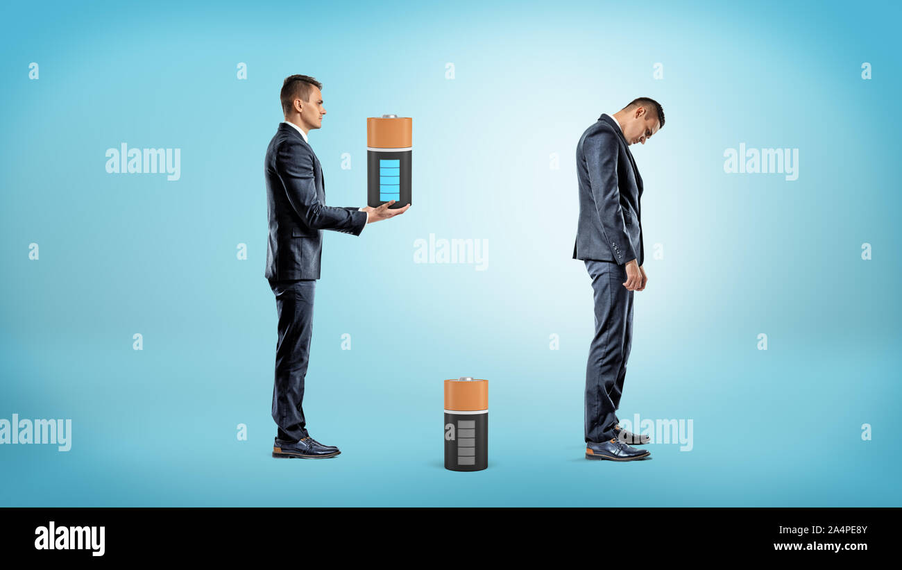 A businessman brings a large fully charged battery to replace a ...