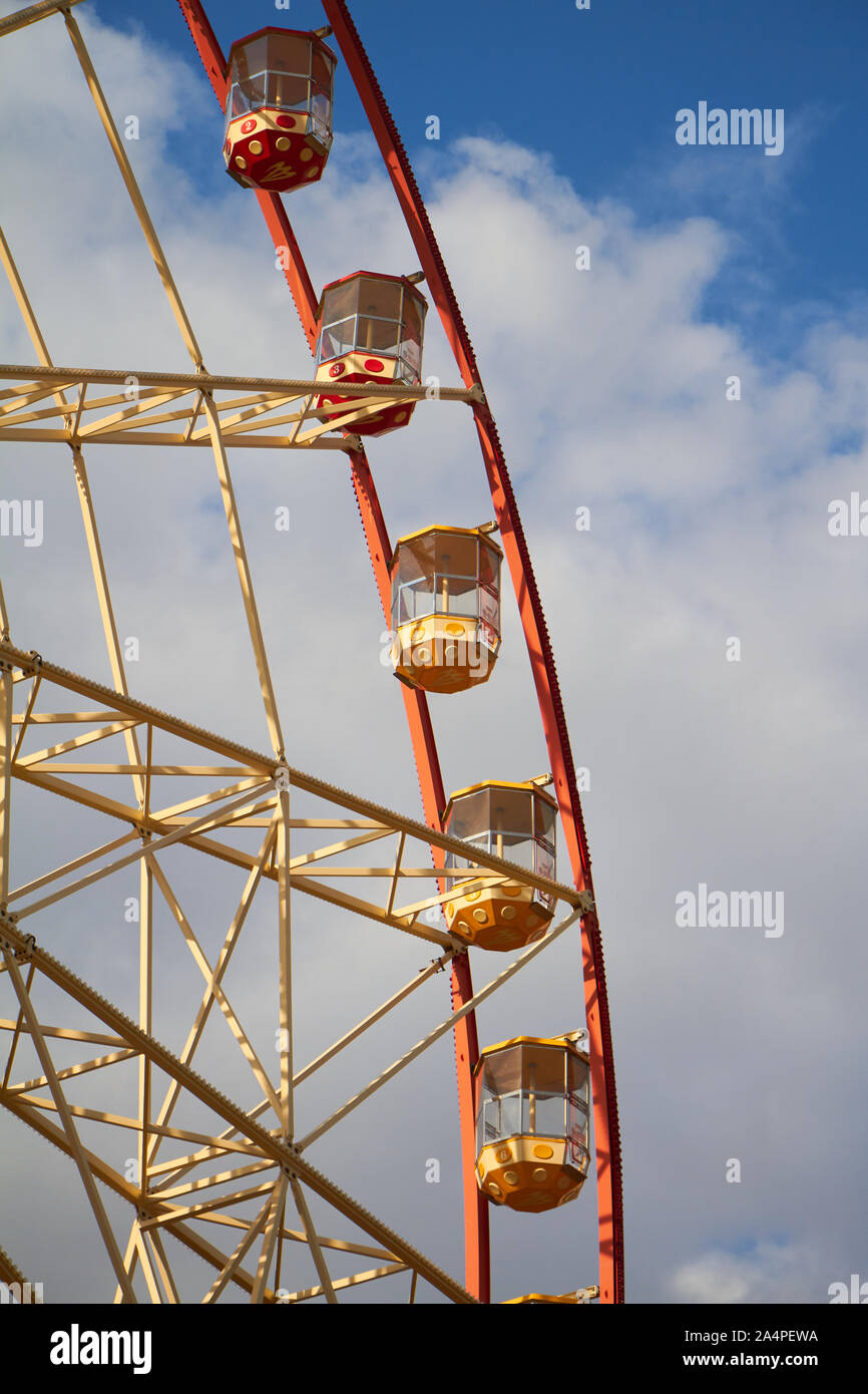 Close up modern Ferris wheel against blue sky and white clouds, fun ...