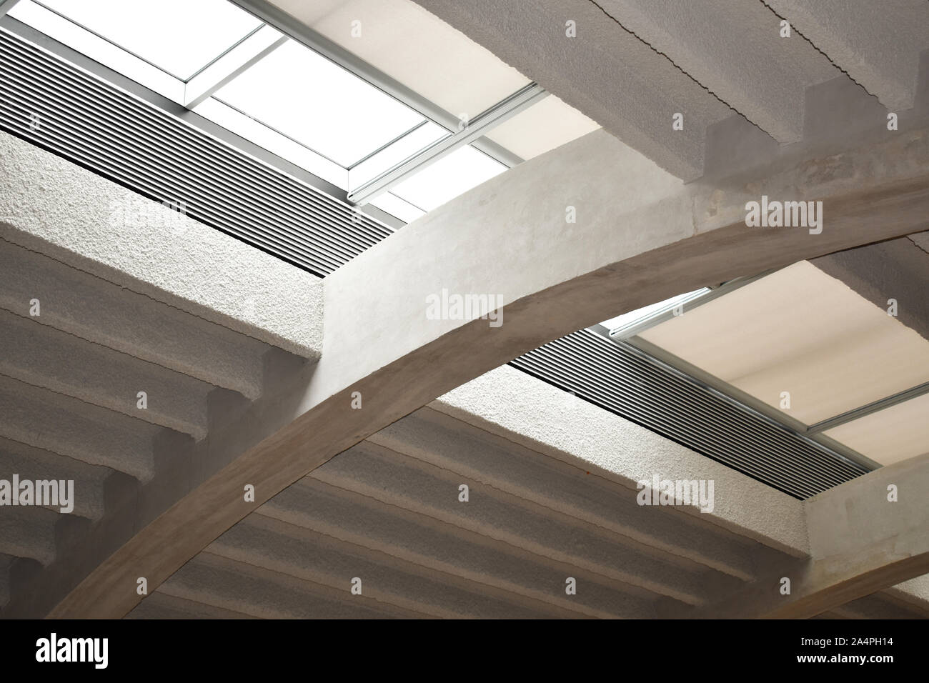 Modern white concrete arched ceiling with top windows and ventilation ...