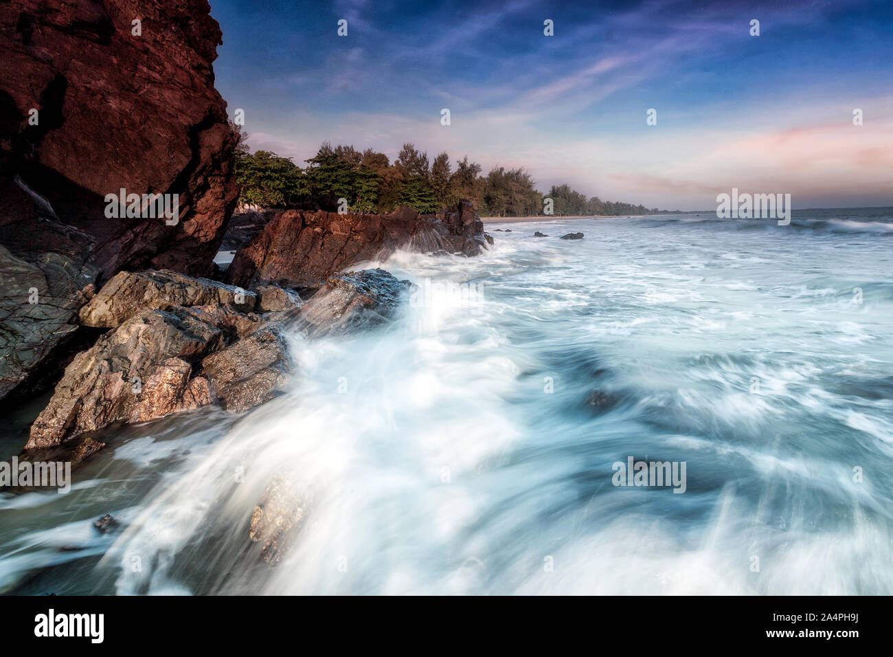 A scenic beauty of splashing wave over coastal rock at Batu Layar beach ...