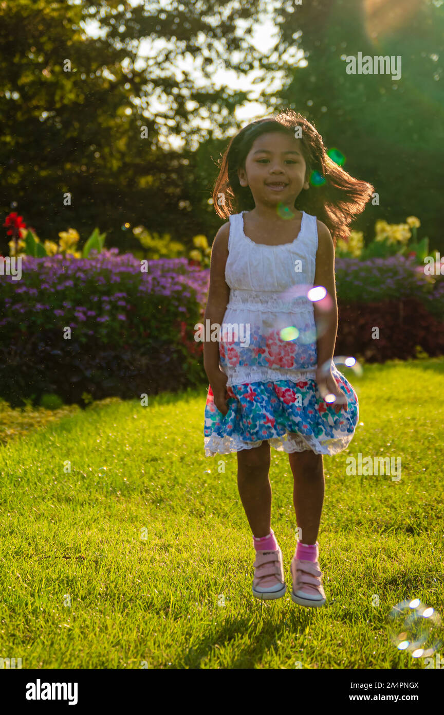 Cute Mexican American children are playing and enjoying bubbles in a ...