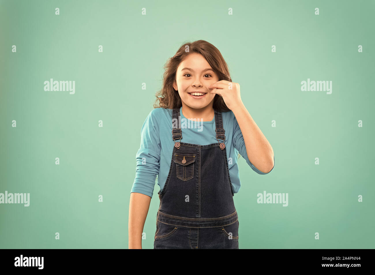 Advantages of the young skin. Happy little girl touching her smooth ...