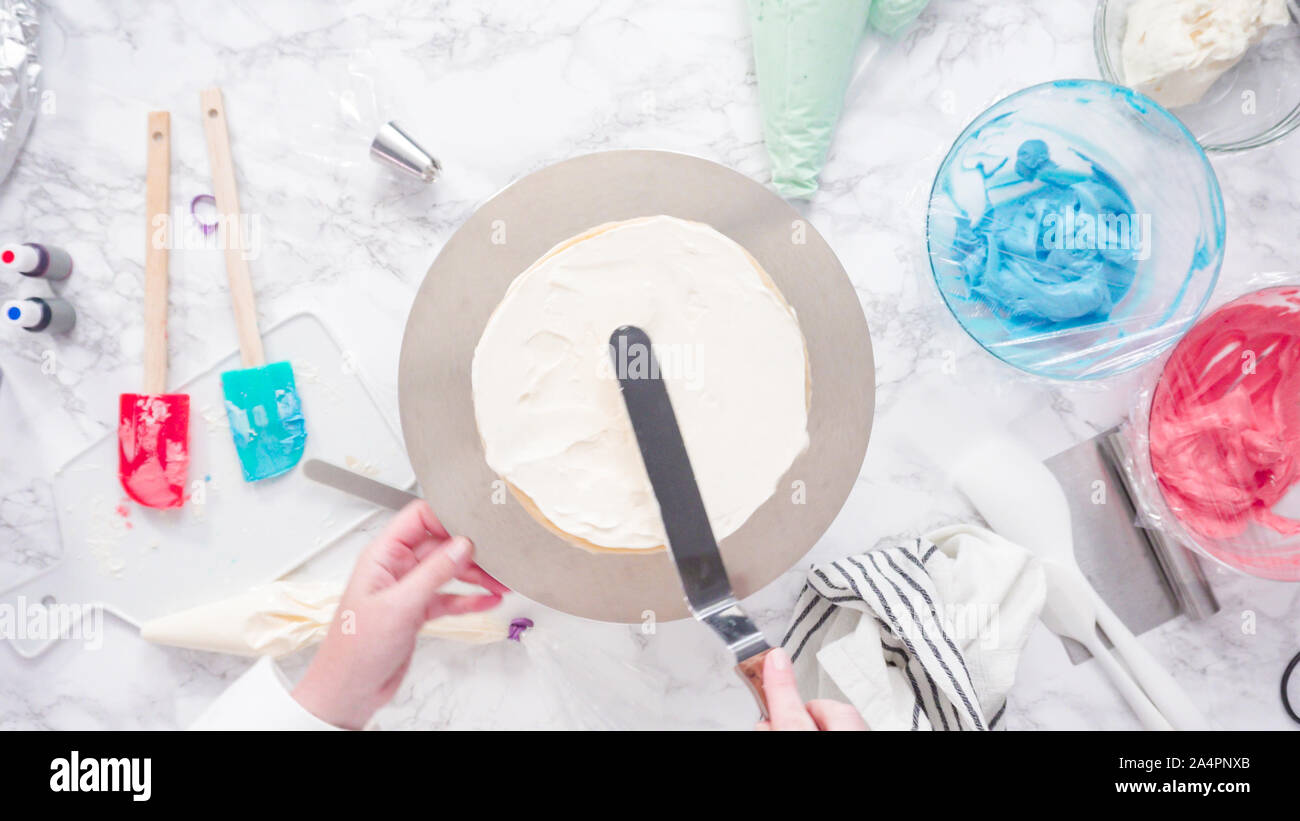 Stacking cake layers to create the round three-layer vanilla cake Stock Photo - Alamy