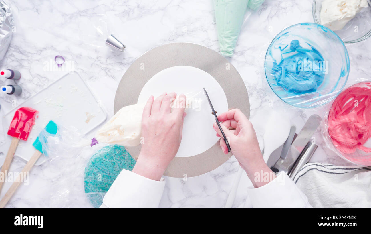 Stacking cake layers to create the round three-layer vanilla cake Stock ...