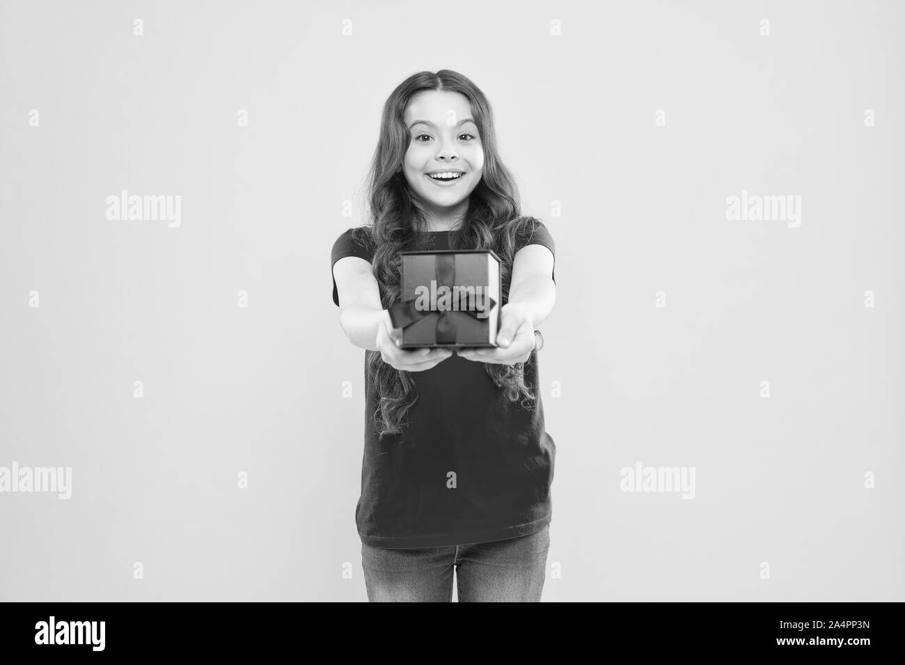 Gift giving makes her happy. Adorable little girl giving blue present ...