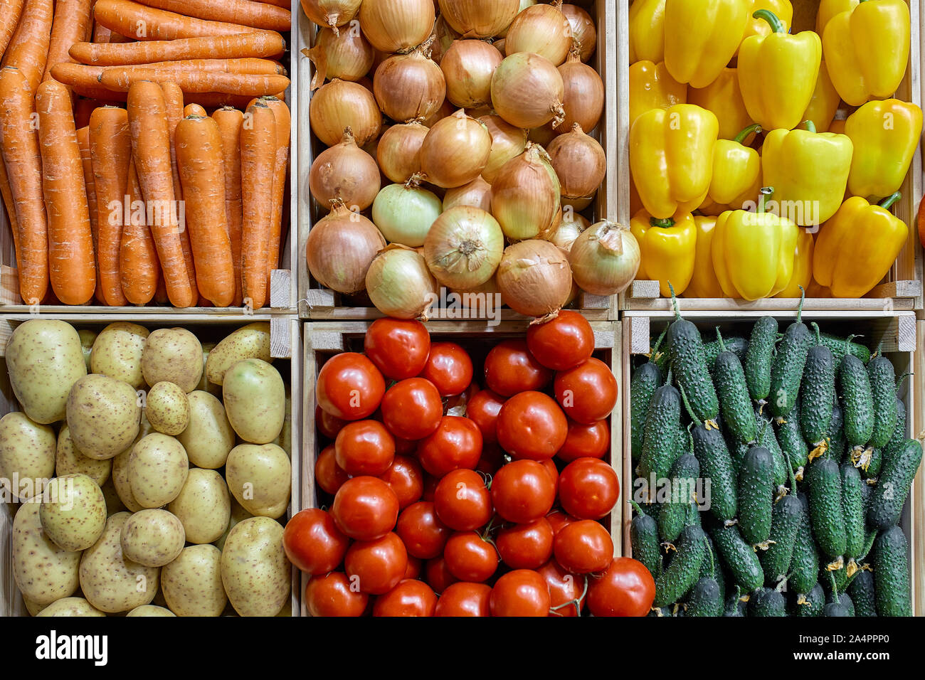 A counter with different vegetables in drawers is beautifully and ...