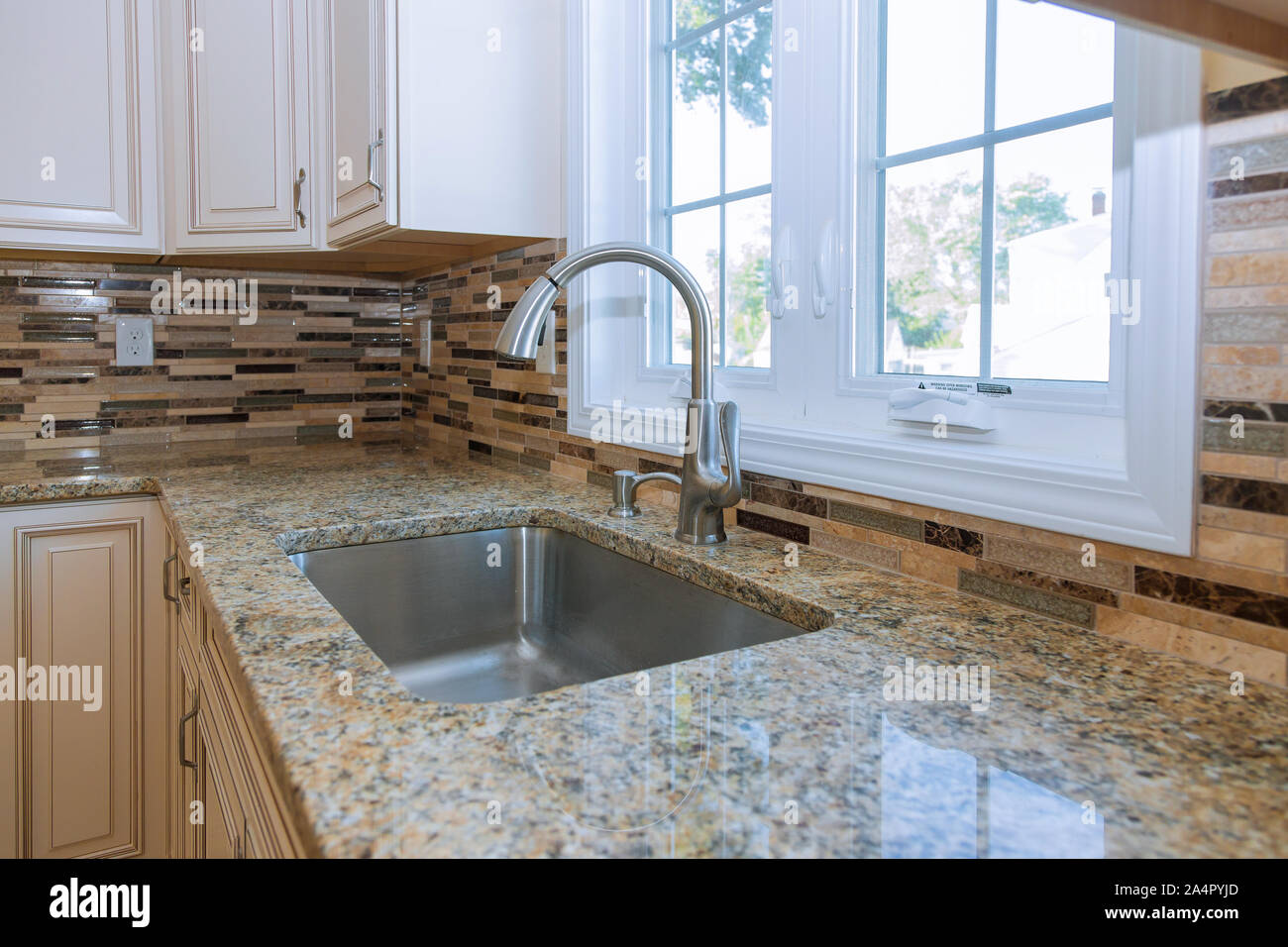 New modern white kitchen with built in chrome water tap Stock Photo - Alamy