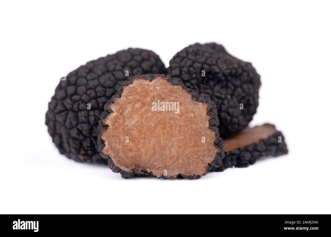 Black truffles isolated on a white background. Fresh sliced truffle ...