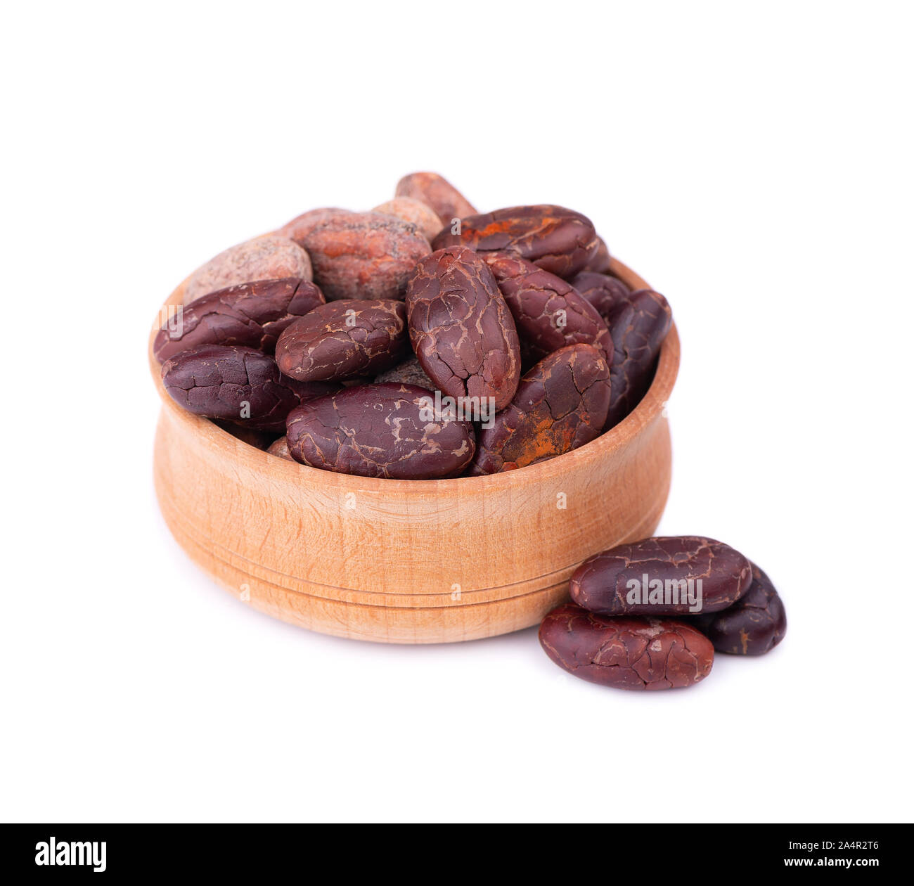 Peeled cocoa beans in the wooden bowl, isolated on white background ...