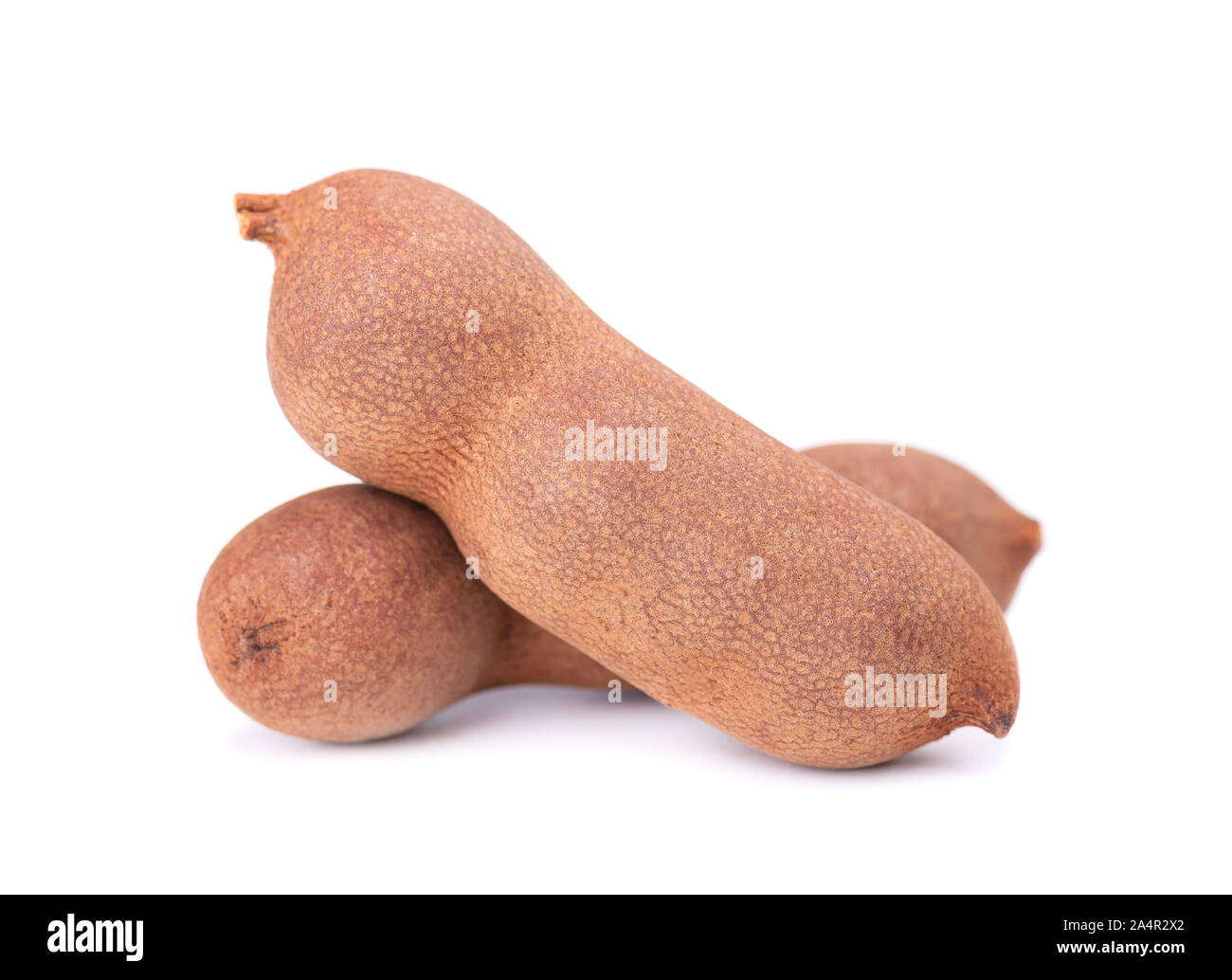 Sweet tamarind isolated on white background. Two fresh whole tamarinds ...