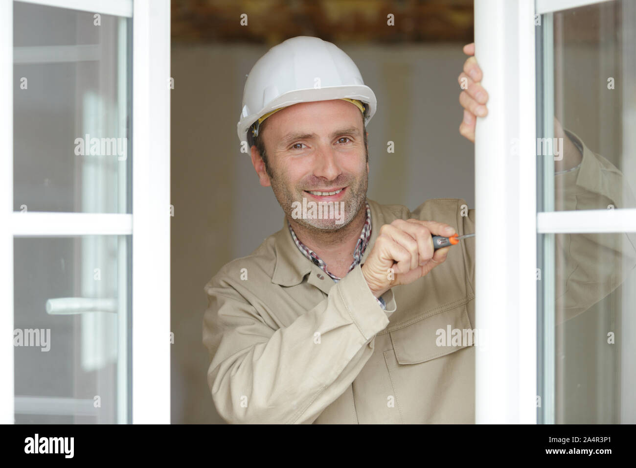 construction worker installing window in house Stock Photo - Alamy
