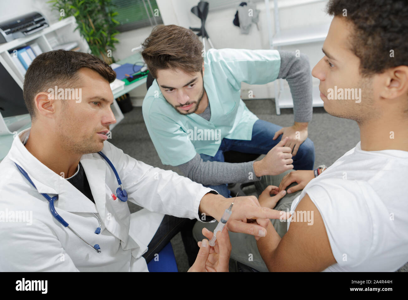young nurse learning to inject a patient Stock Photo - Alamy