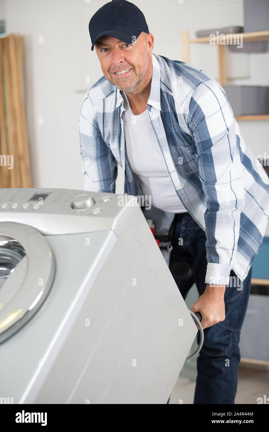 Person carrying a washing machine hi-res stock photography and images ...