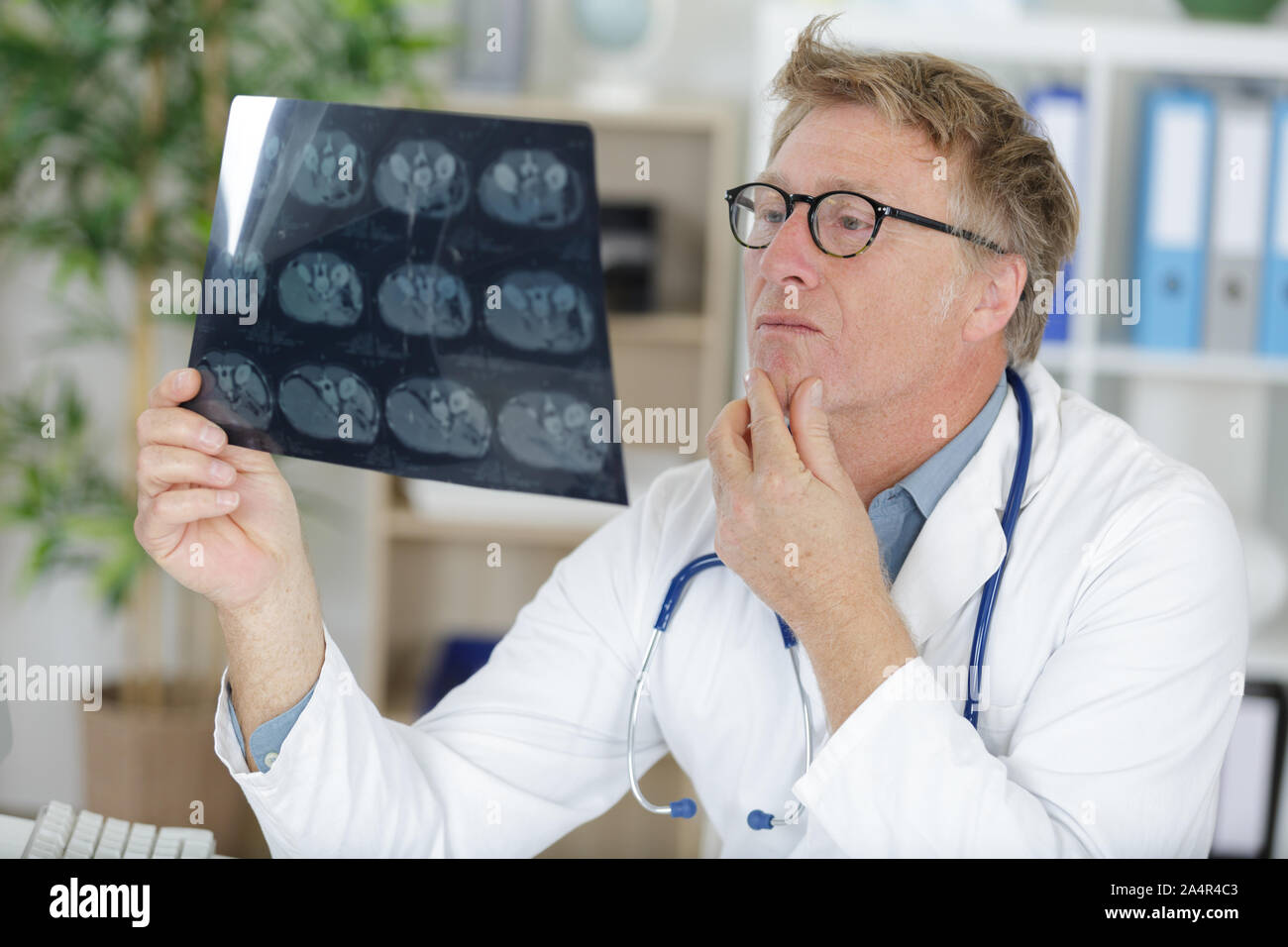 a radiologist looking at x-ray Stock Photo - Alamy