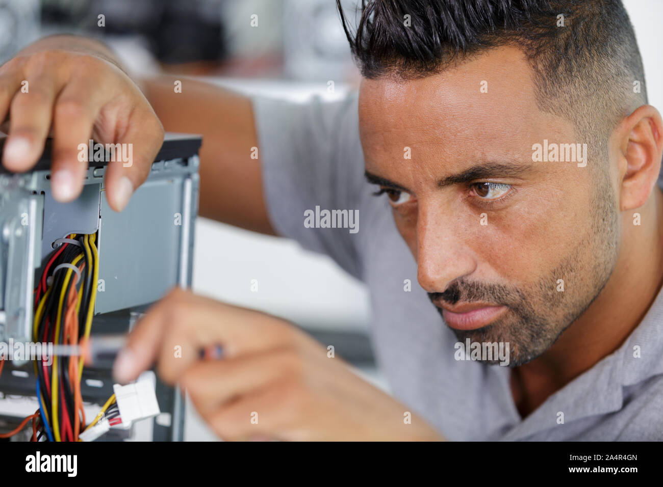 a man fixing a pc Stock Photo - Alamy