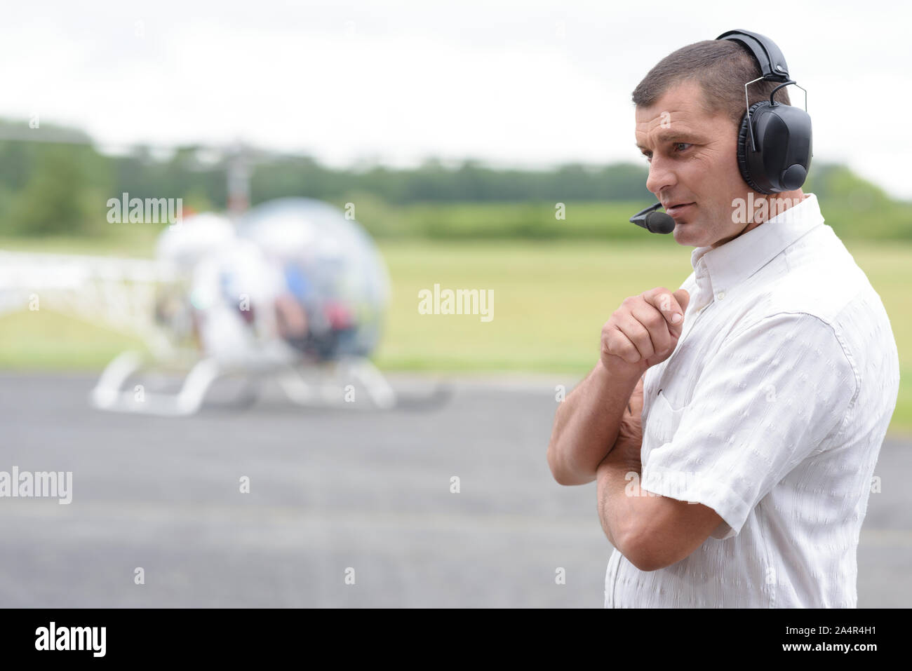 portrait of man standing in front of helicopter Stock Photo - Alamy