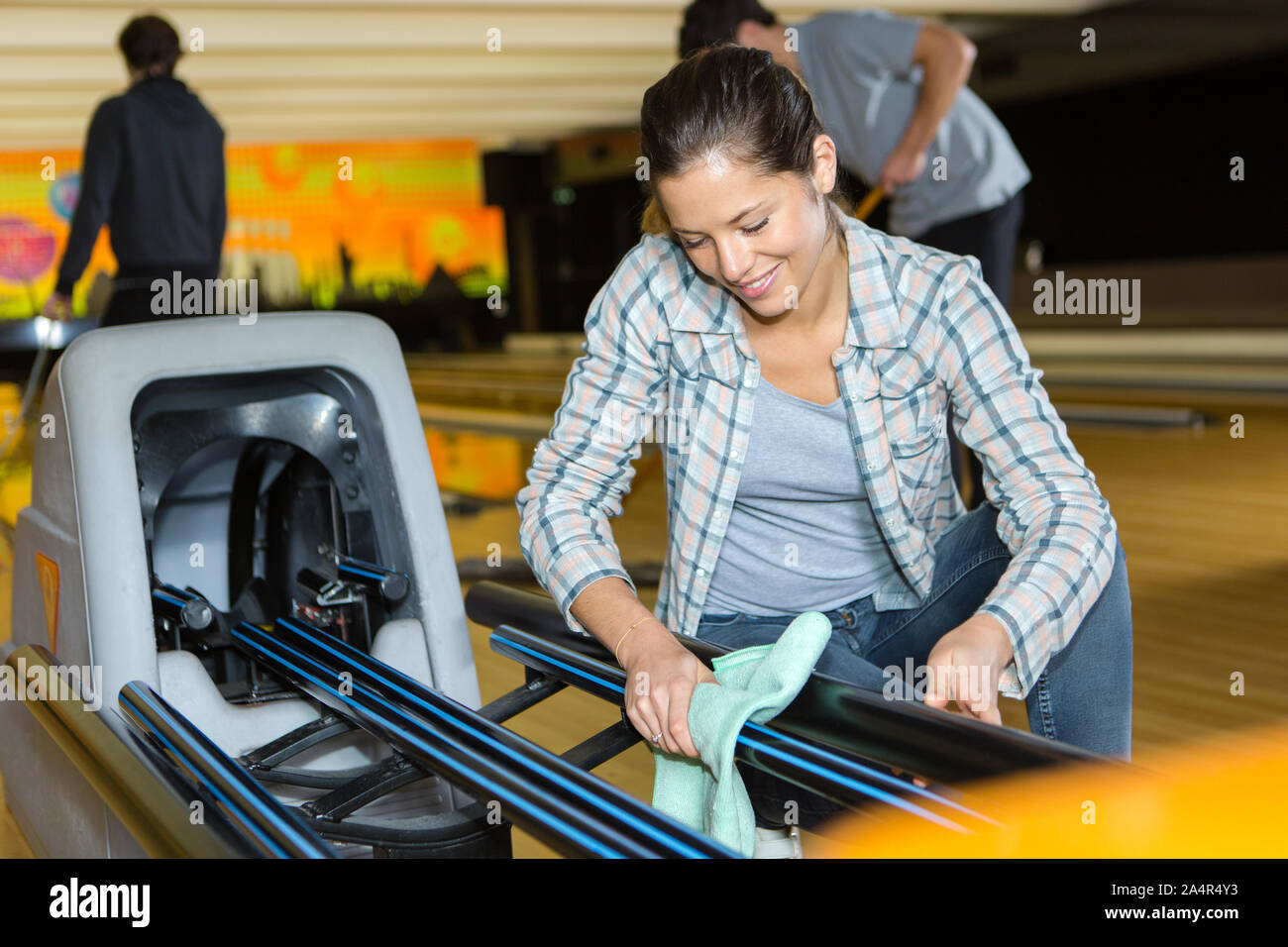 bowling club worker cleaning Stock Photo - Alamy