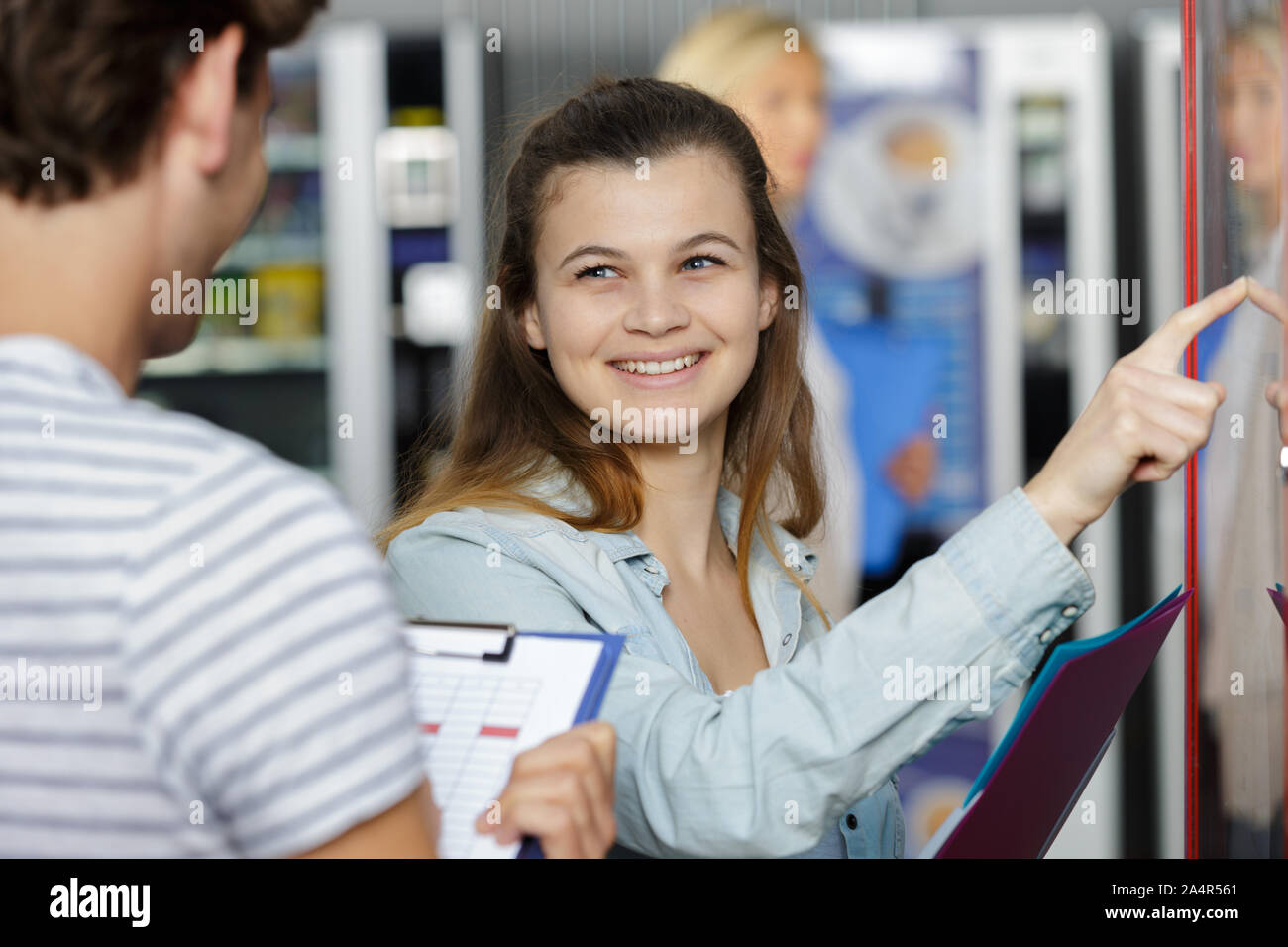 young couple next to a vending machine Stock Photo - Alamy